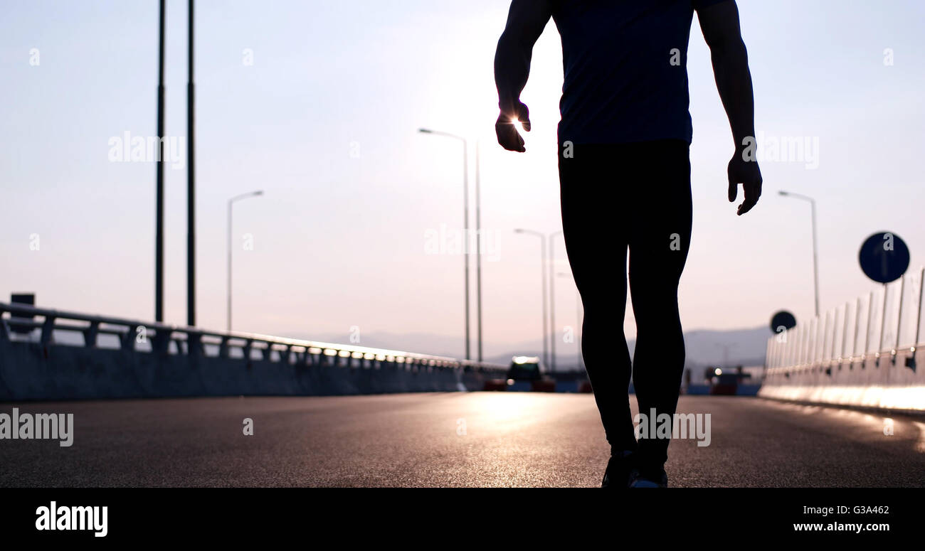 Running at sunrise man exercising for marathon and workout fitness ...