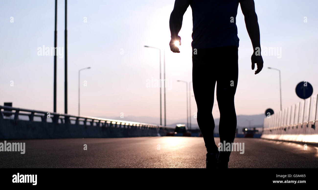 Running at sunrise man exercising for marathon and workout fitness ...