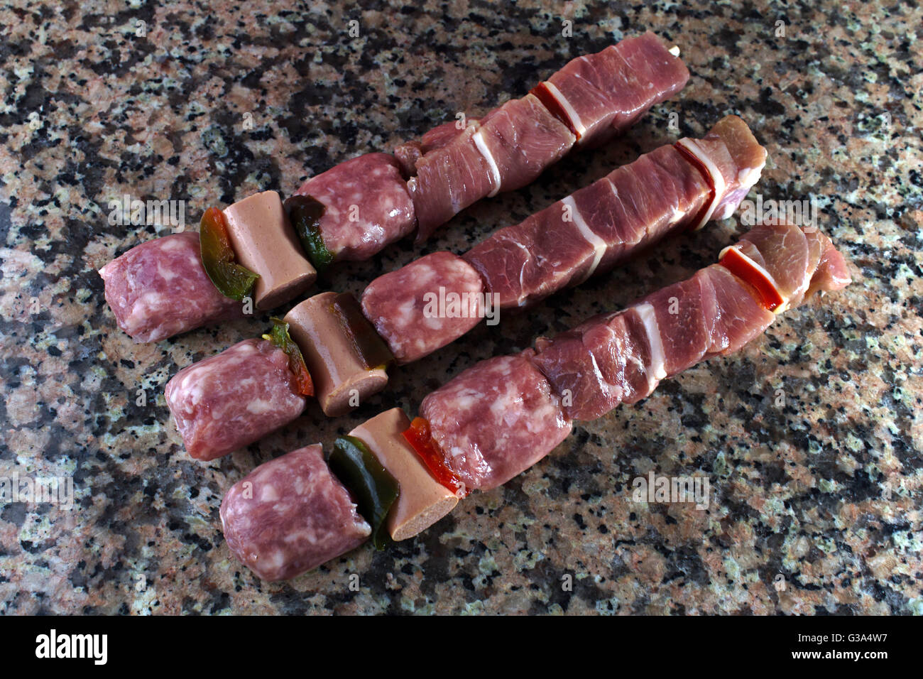 Assortment of raw brochette meat both of pork and beef, with vegetables ...