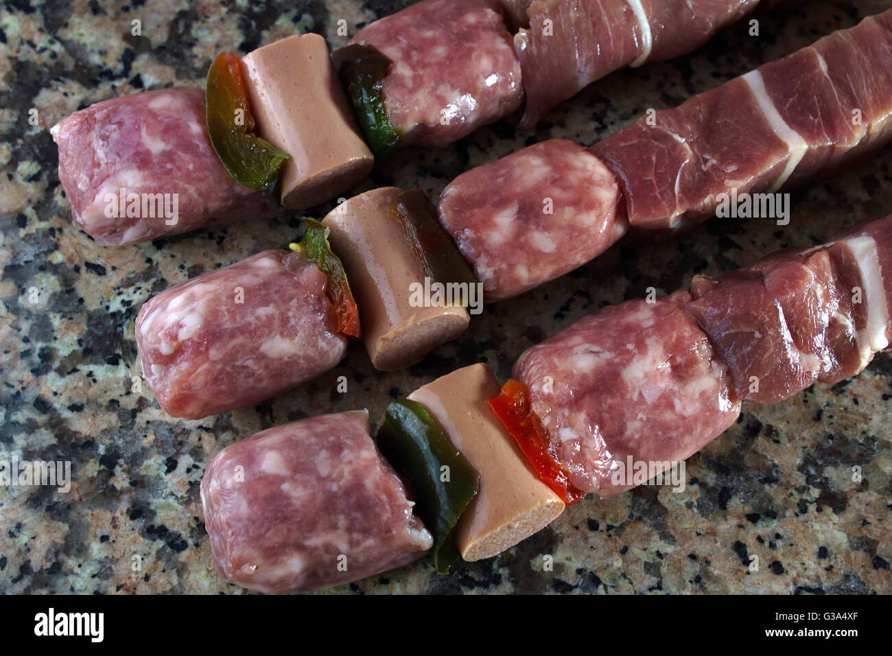 Assortment of raw brochette meat both of pork and beef, with vegetables ...