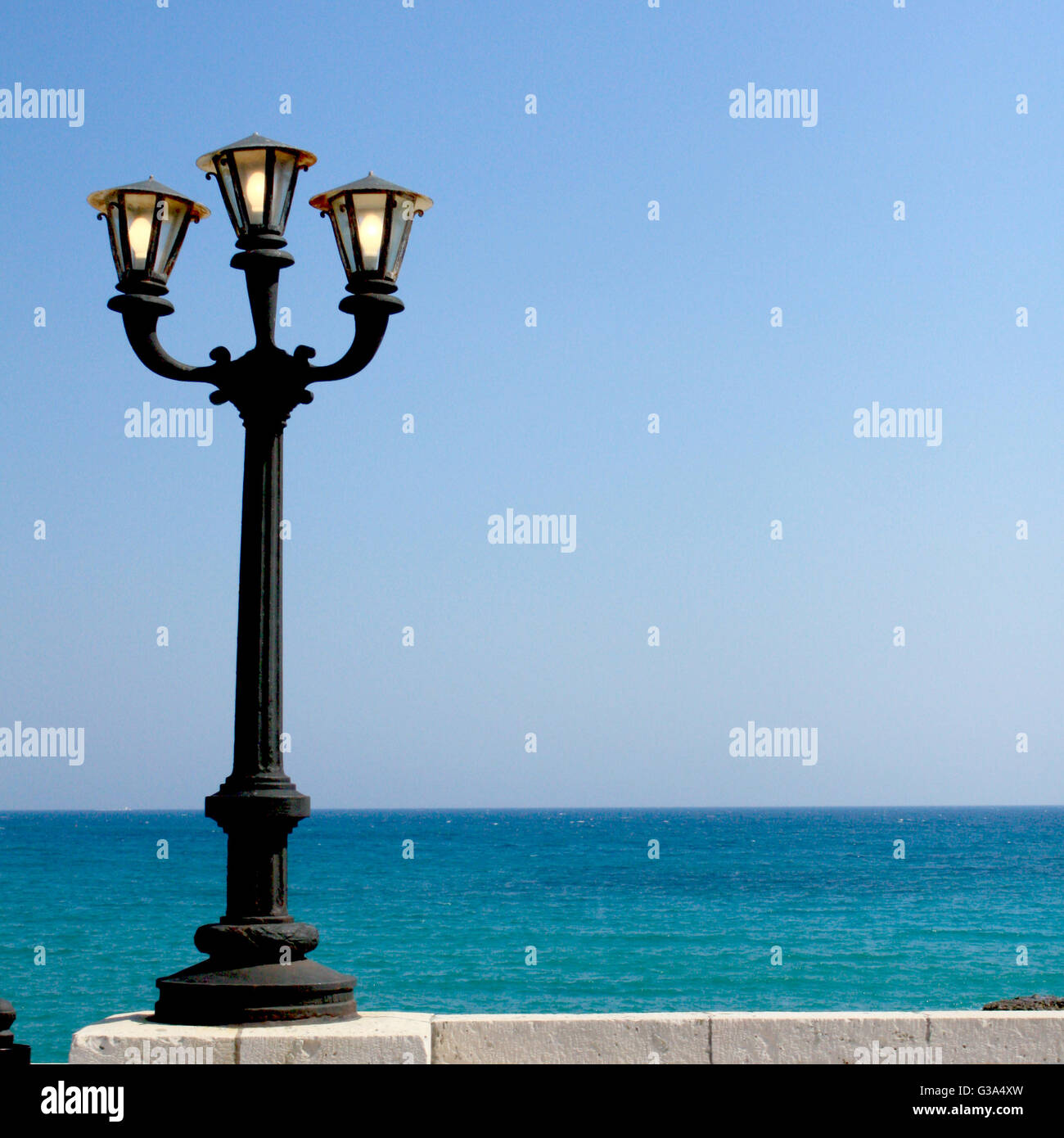 Lamp post and sea horizon in Puglia, Italy Stock Photo - Alamy