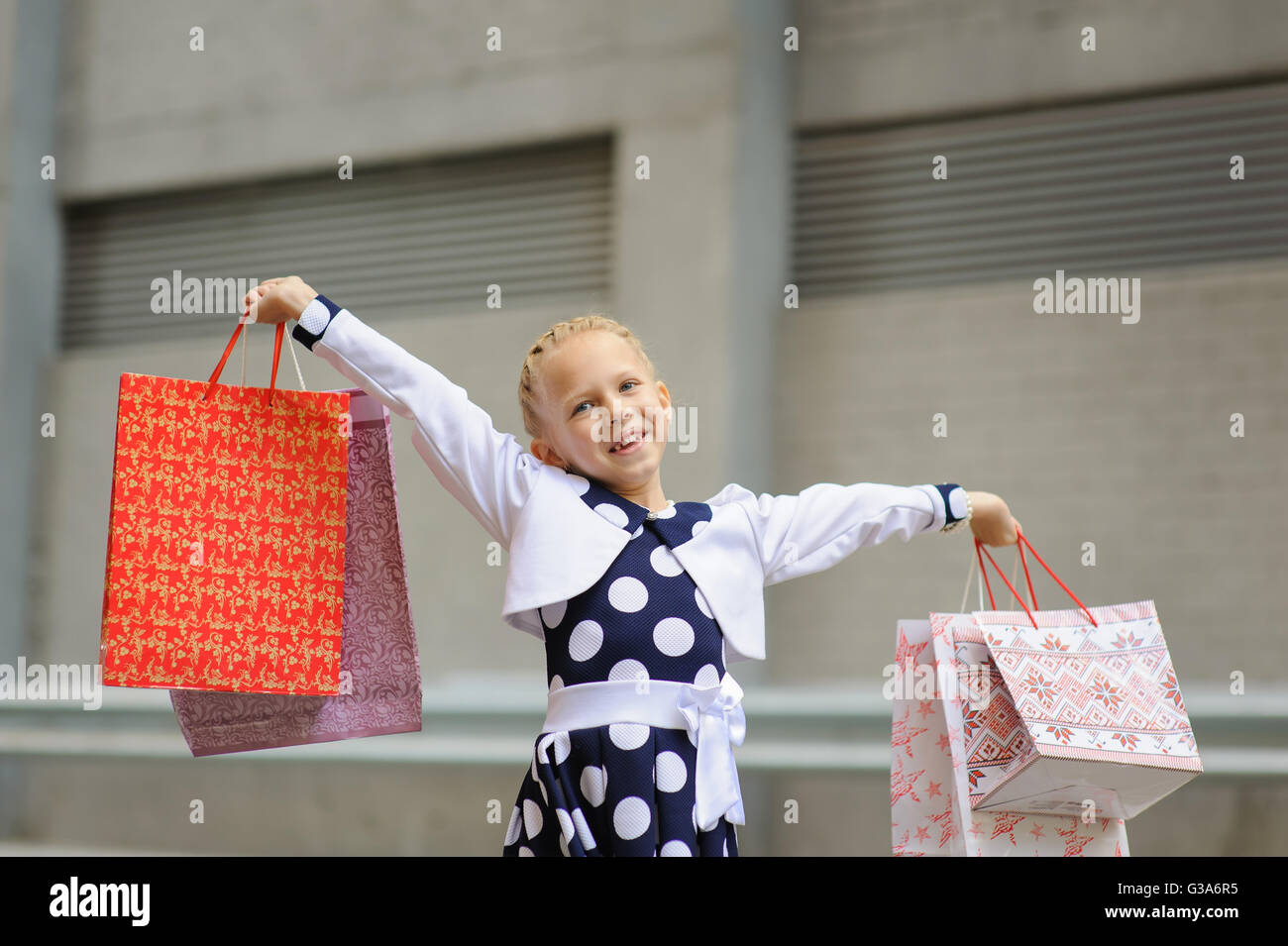 Happy little girl with shopping bags. Cute little girl on shopping ...