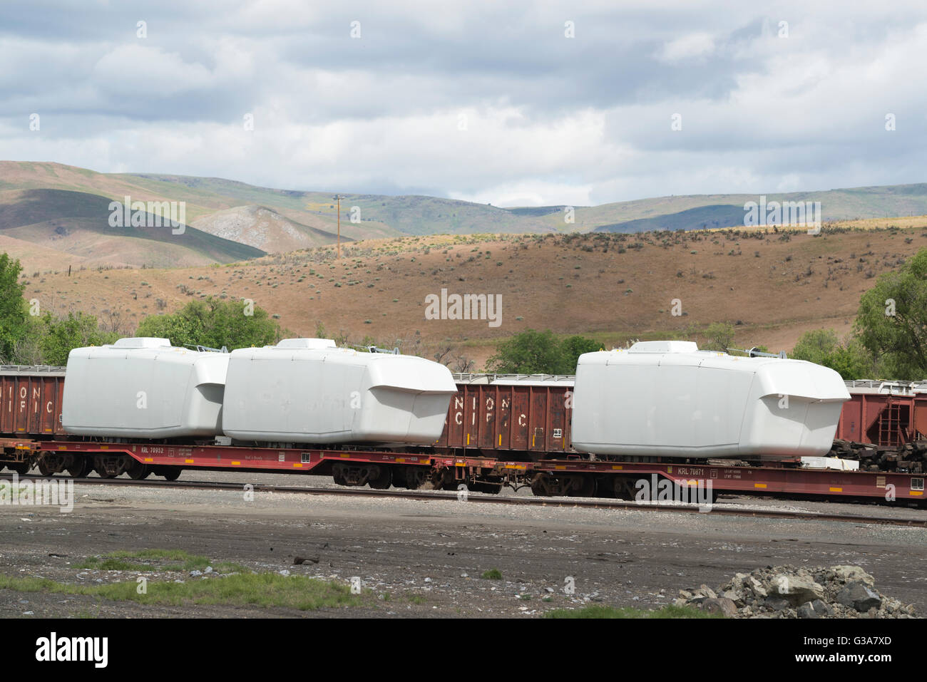 Wind turbine generators on railroad cars await offloading in the ...