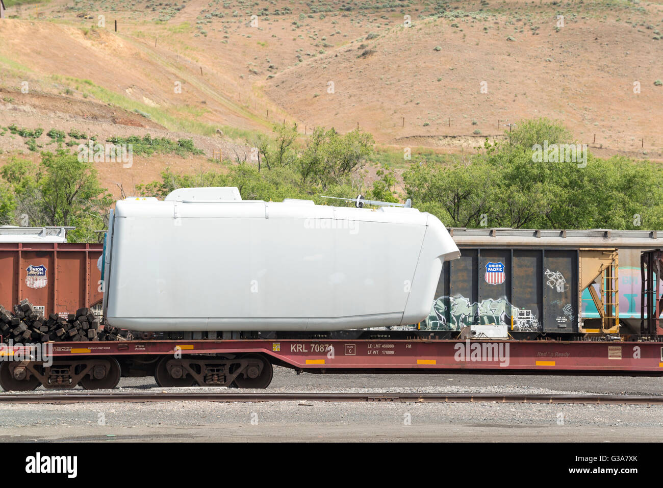 Wind turbine generators on railroad cars await offloading in the ...