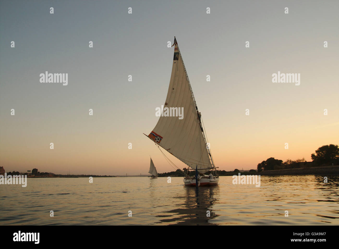 Felucca cruise on the river Nile in evening light, between Aswan and ...