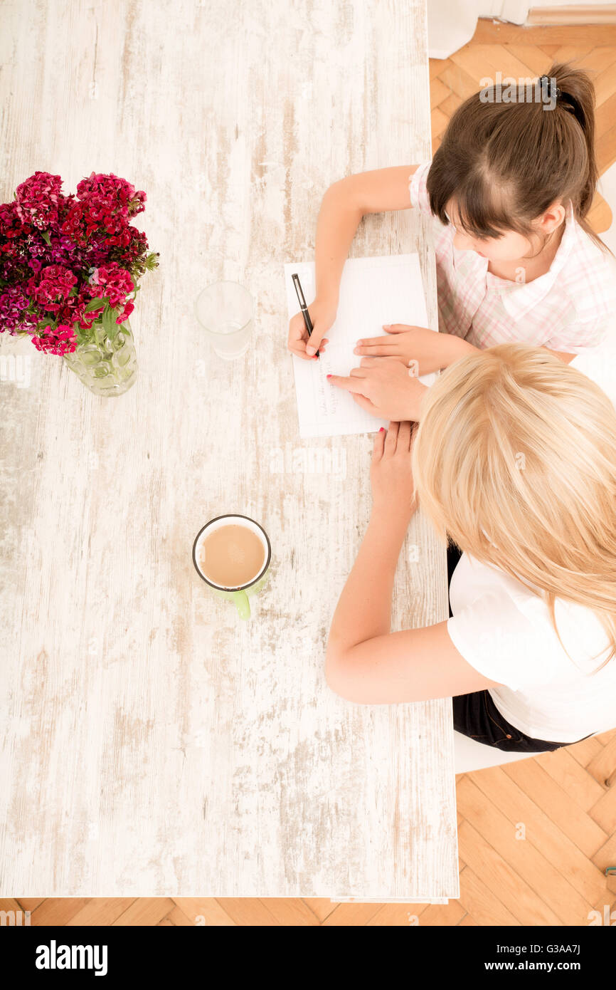 A mother helping her daughter with the homework seen from above Stock ...