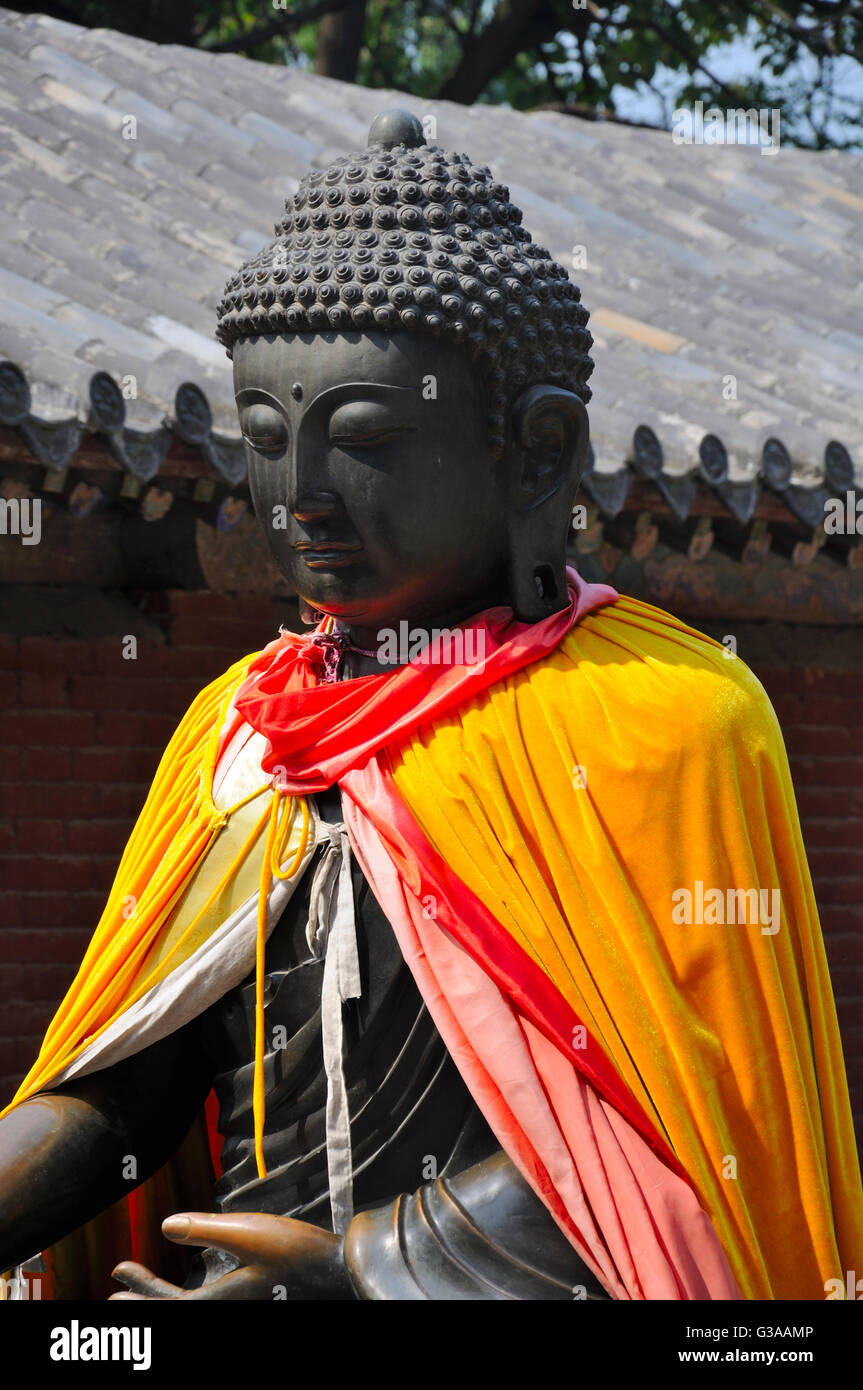 A metal Buddha statue wrapped in silk robes at the Shaolin Temple in ...