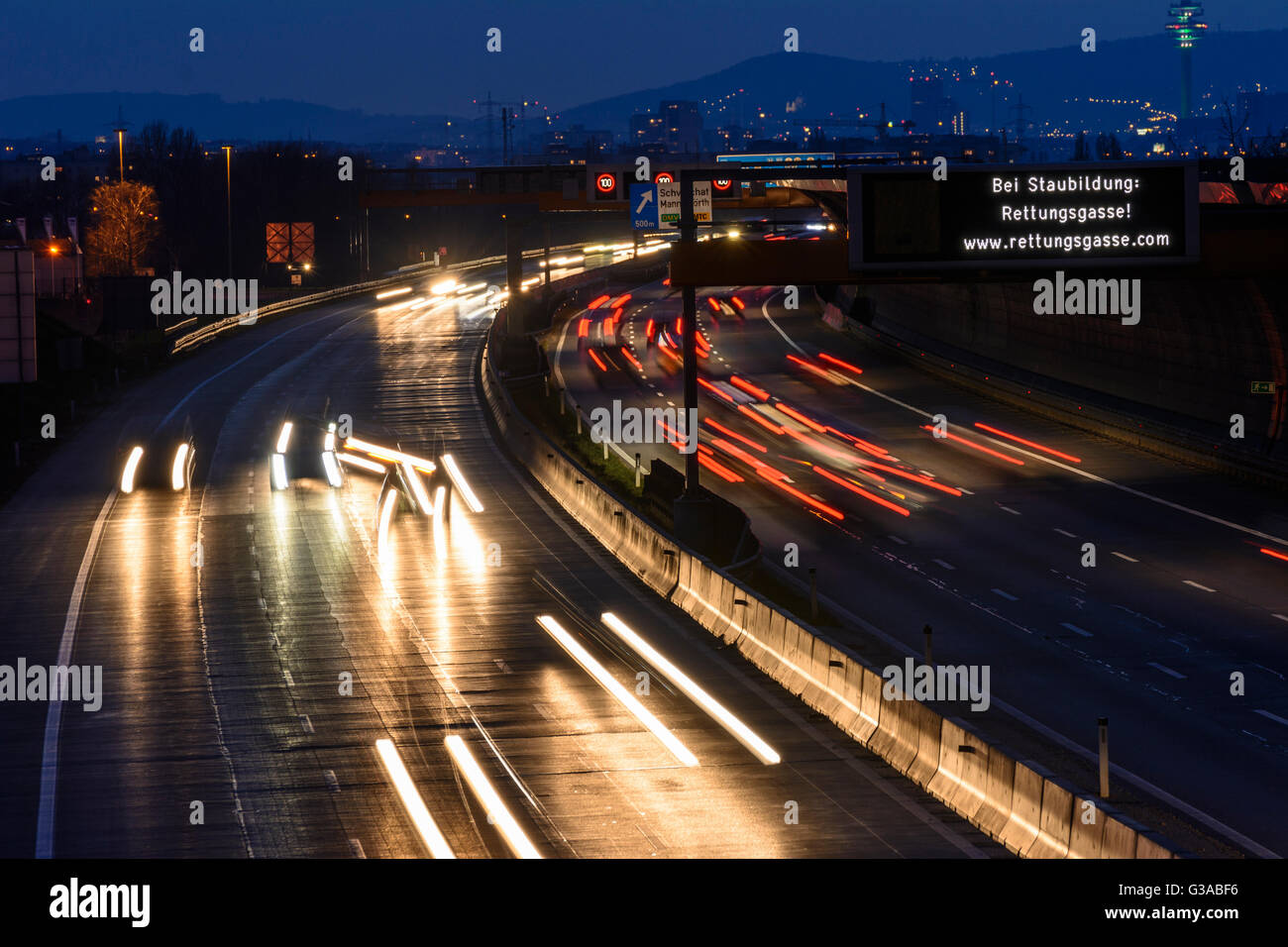 Motorway with light trails of cars and sign for rescuing alley, Austria ...