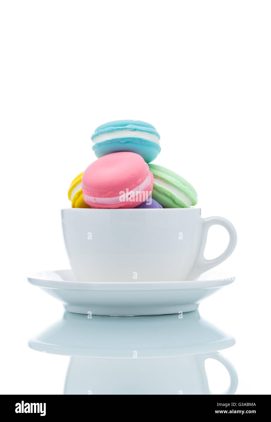 French colorful macarons stacks in coffee cup on white background Stock ...