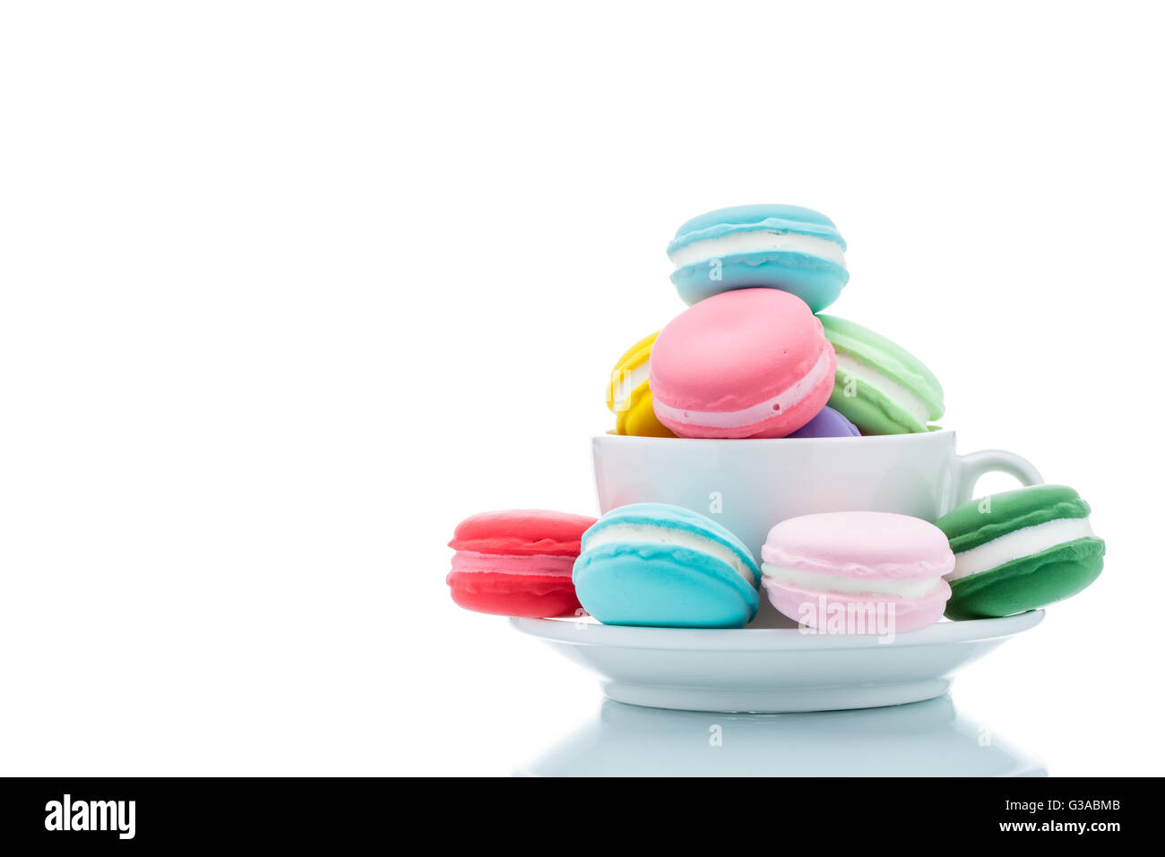 French colorful macarons stacks in coffee cup on white background Stock ...