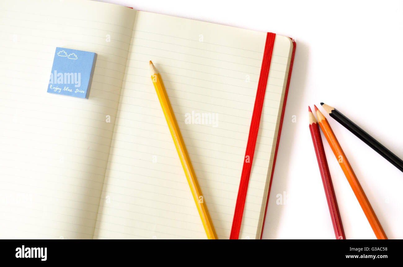 pencils, post it notes and notebook, on desk Stock Photo - Alamy