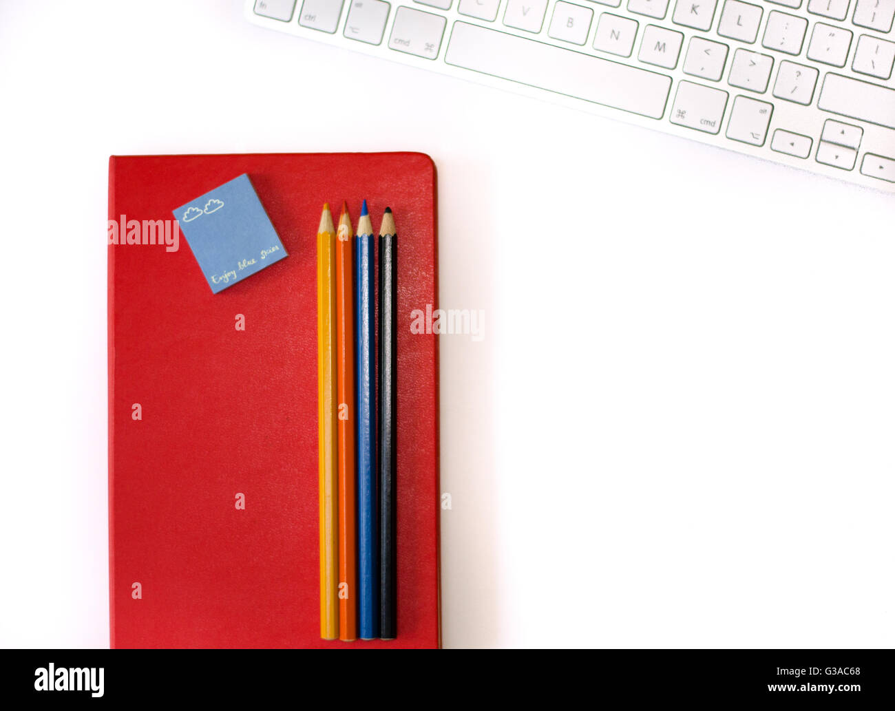 pencils, post it notes and notebook, on desk Stock Photo - Alamy