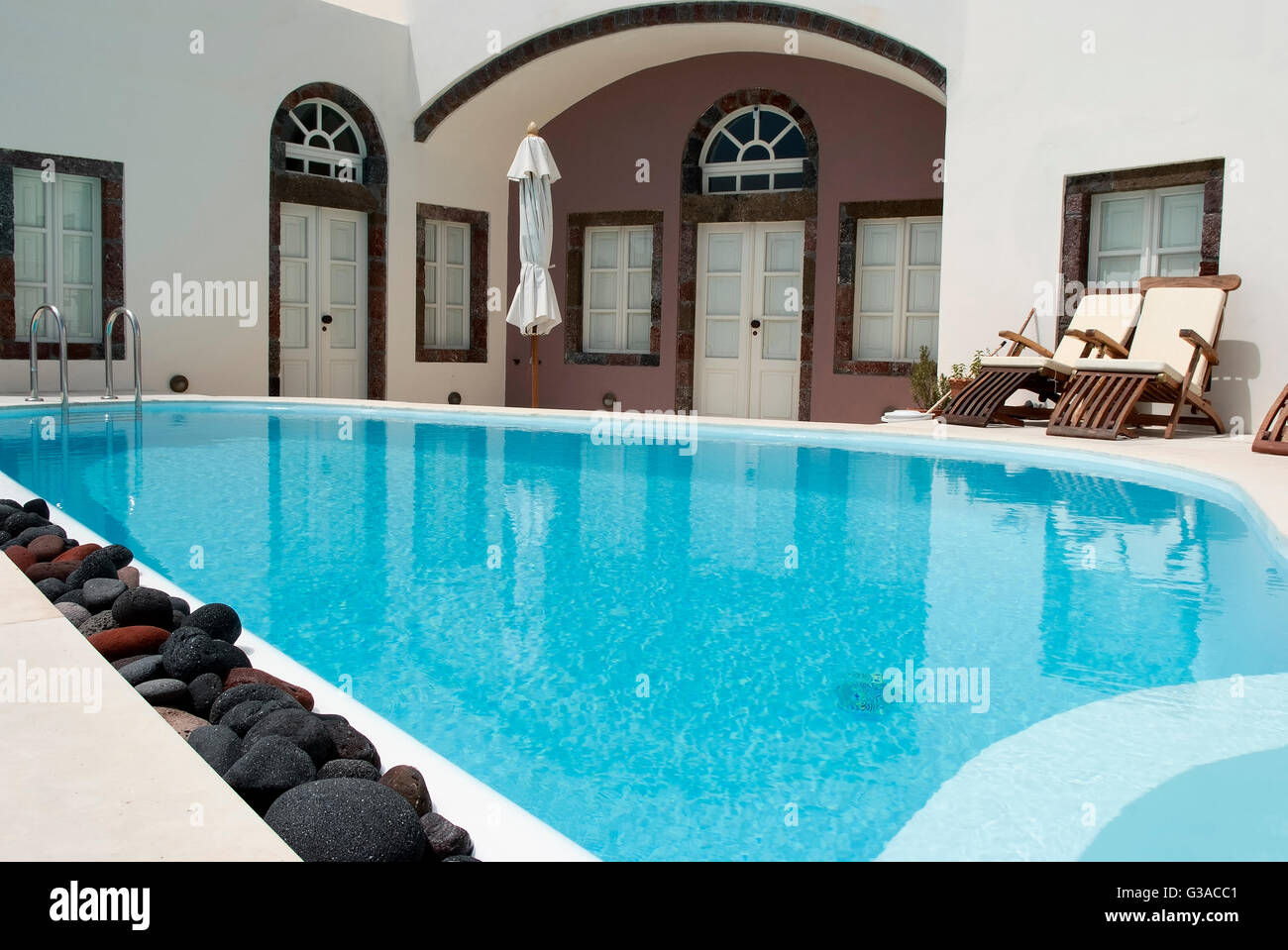 Colorful volcanic stones next to a swimming pool Stock Photo - Alamy