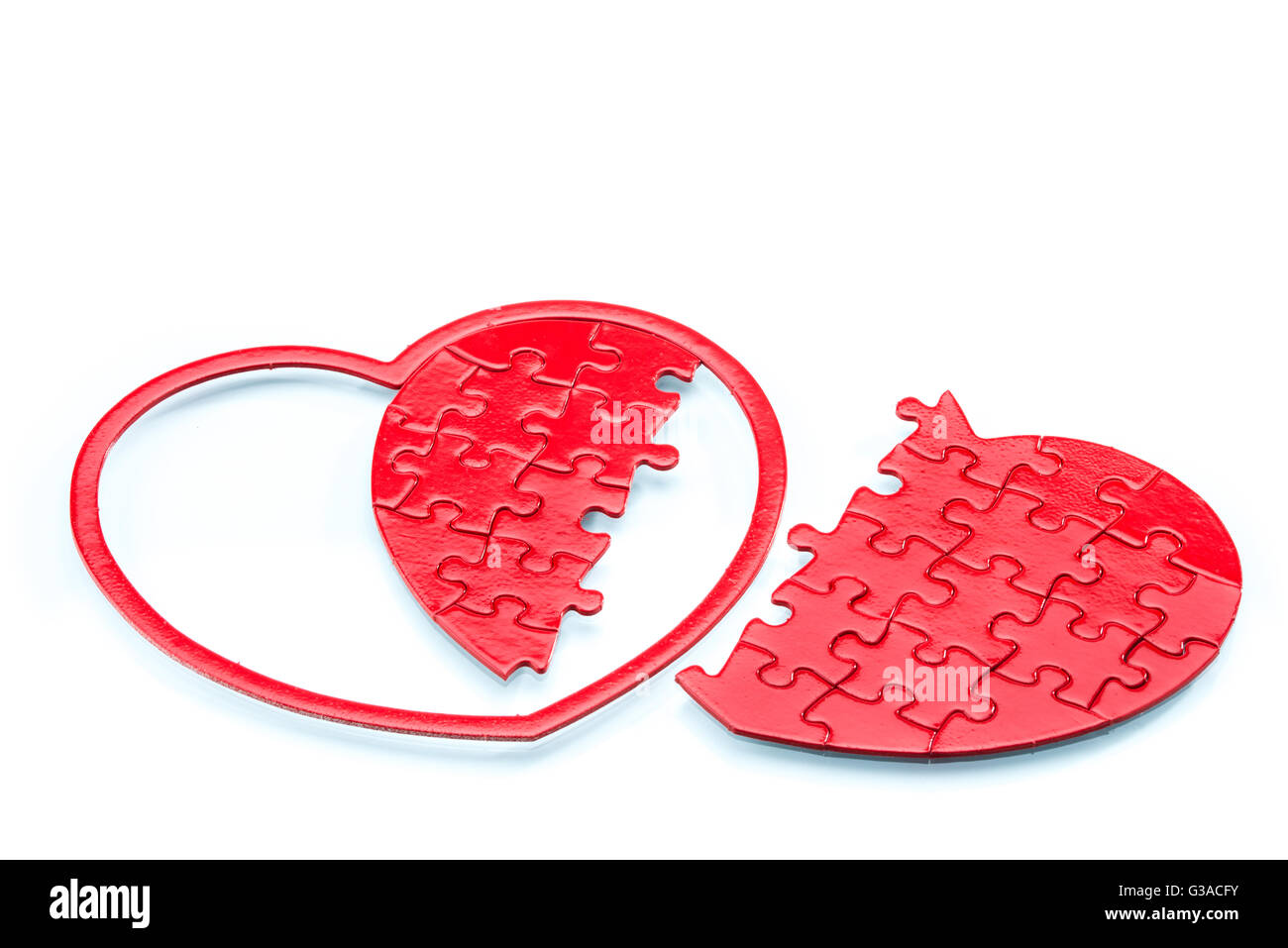 Split heart-shaped puzzle, on white background, relation broken Stock ...