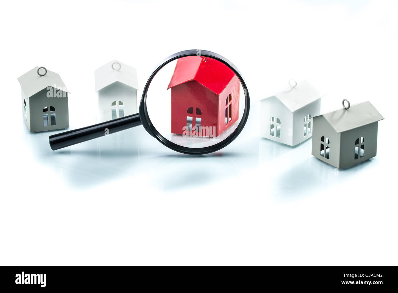 house search concept, house model with magnifying on white background ...