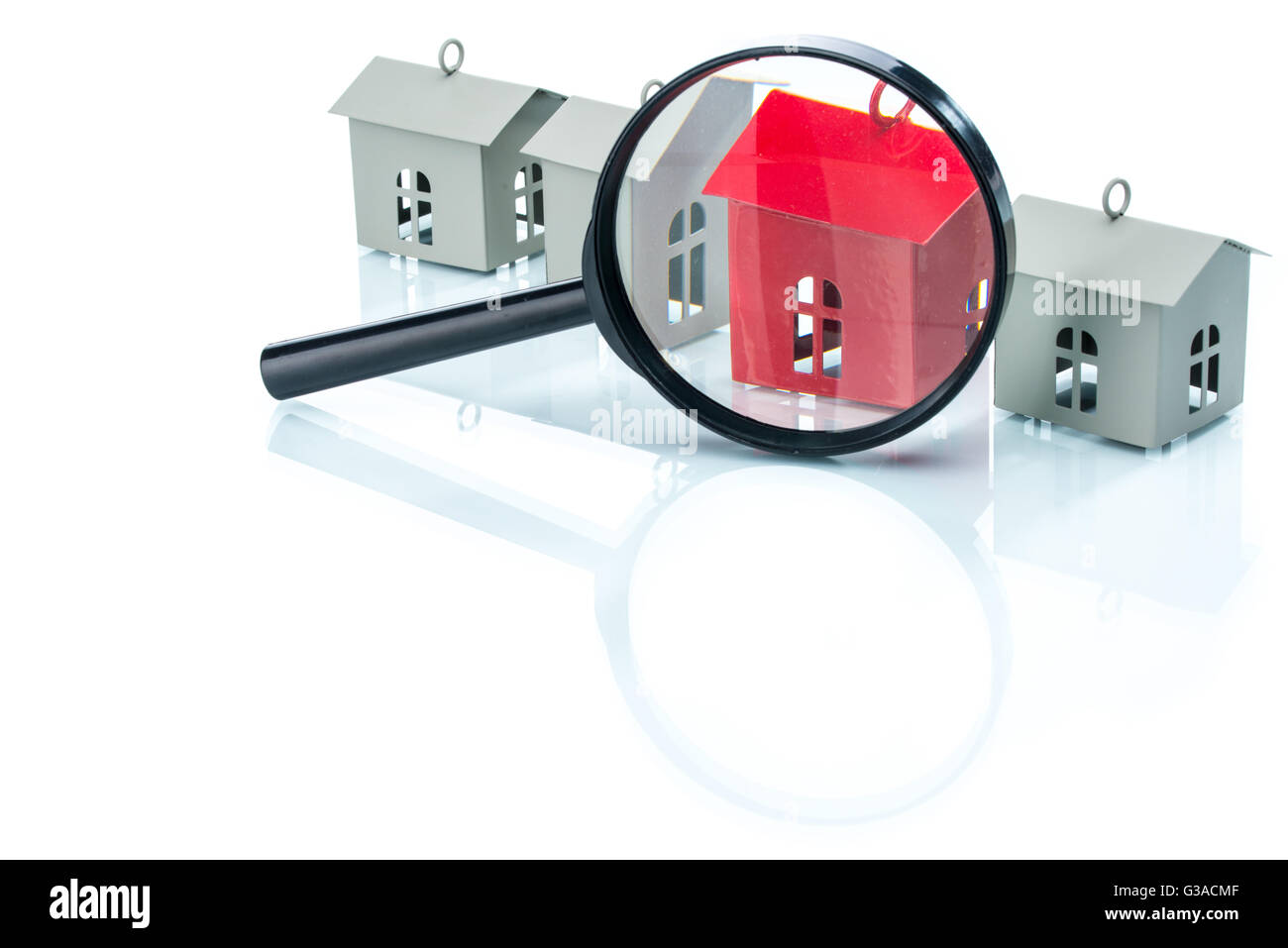 house search concept, house model with magnifying on white background ...