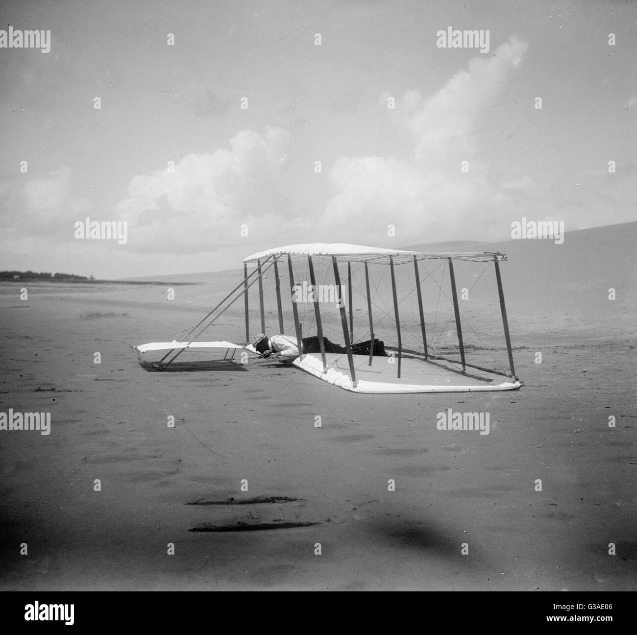 Wilbur Wright in prone position on glider just after landing Stock ...