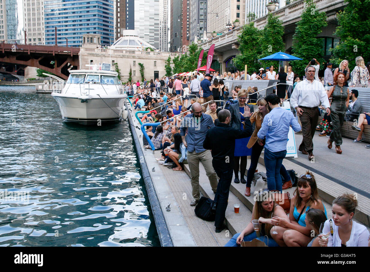 A crowd of people enjoying a nice day on the Chicago Riverwalk Stock ...