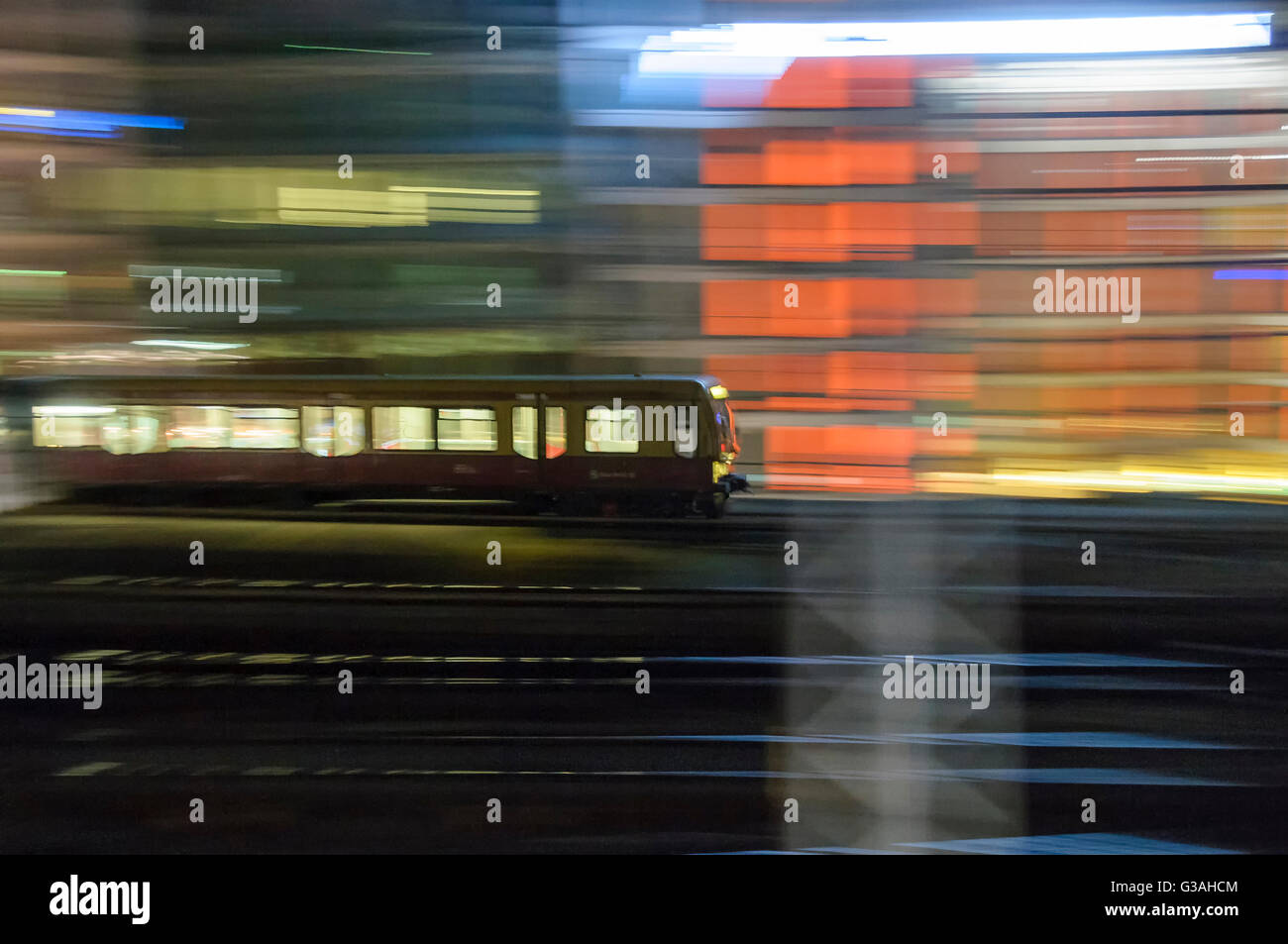 Train accelerating from the station at night, blur to show the speed ...