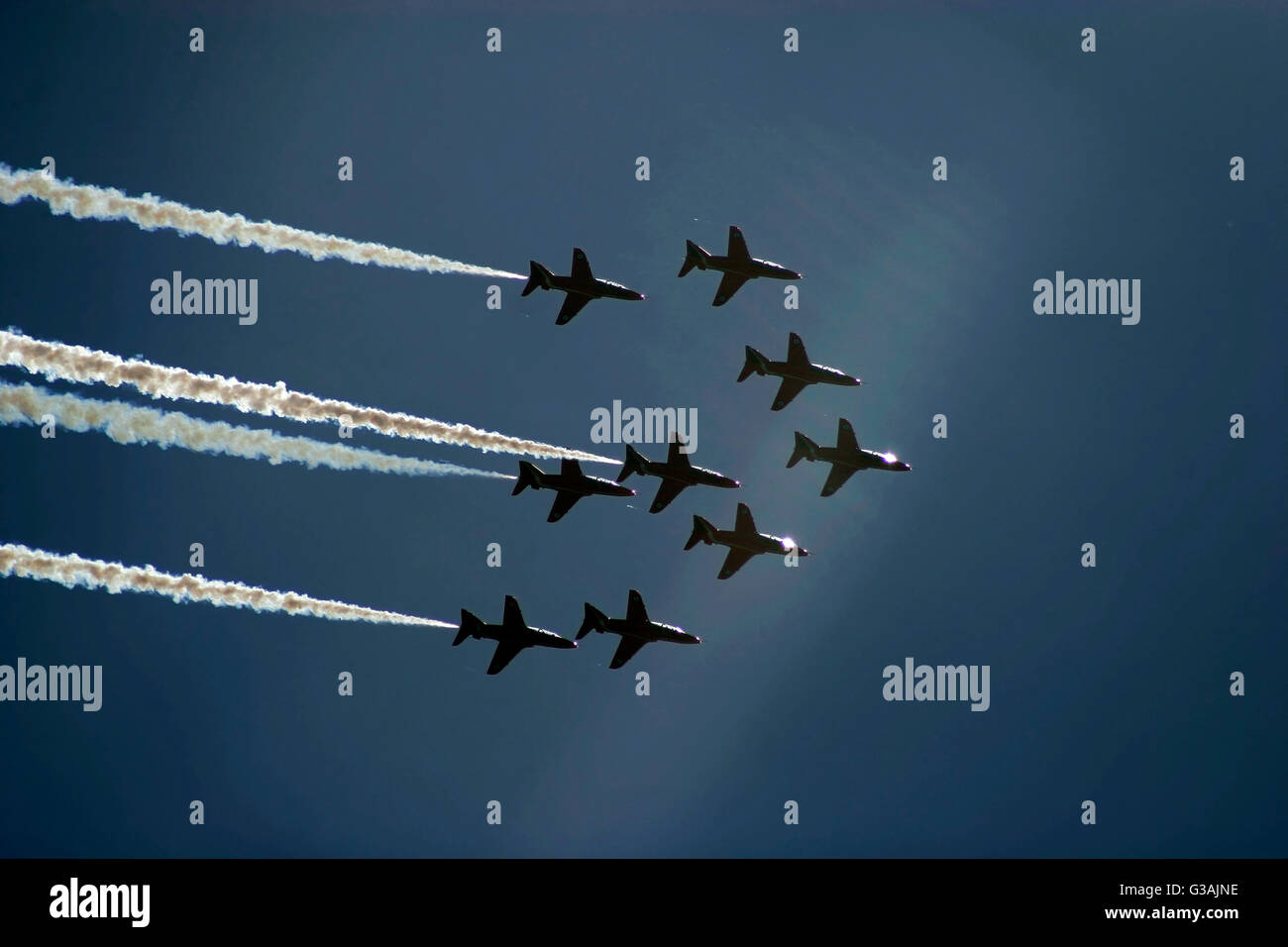 The Red Arrows aerobatic display team flying in formation against a ...