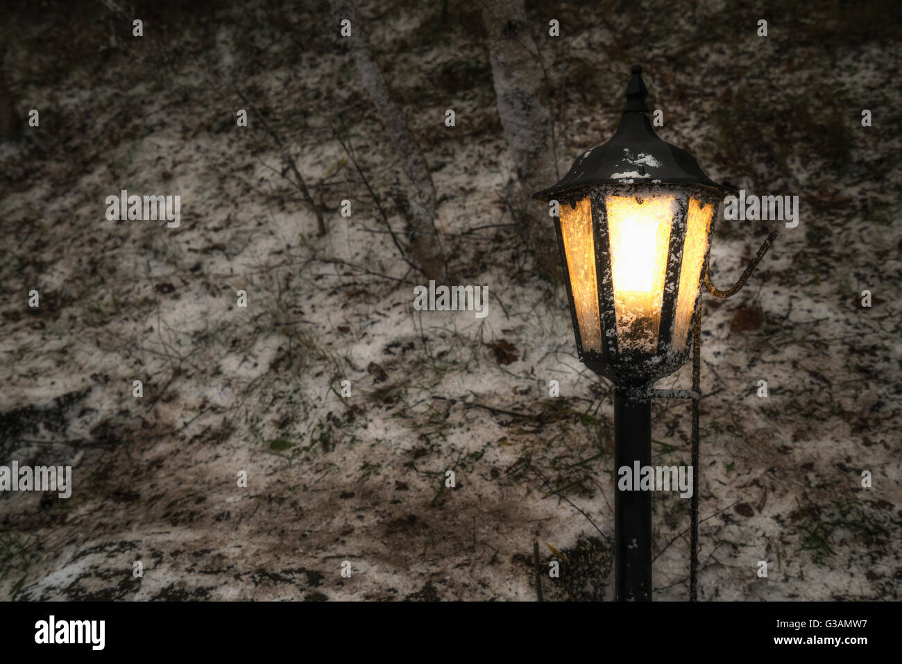Illuminated lamp post against a stone wall; Beamish, England Stock ...