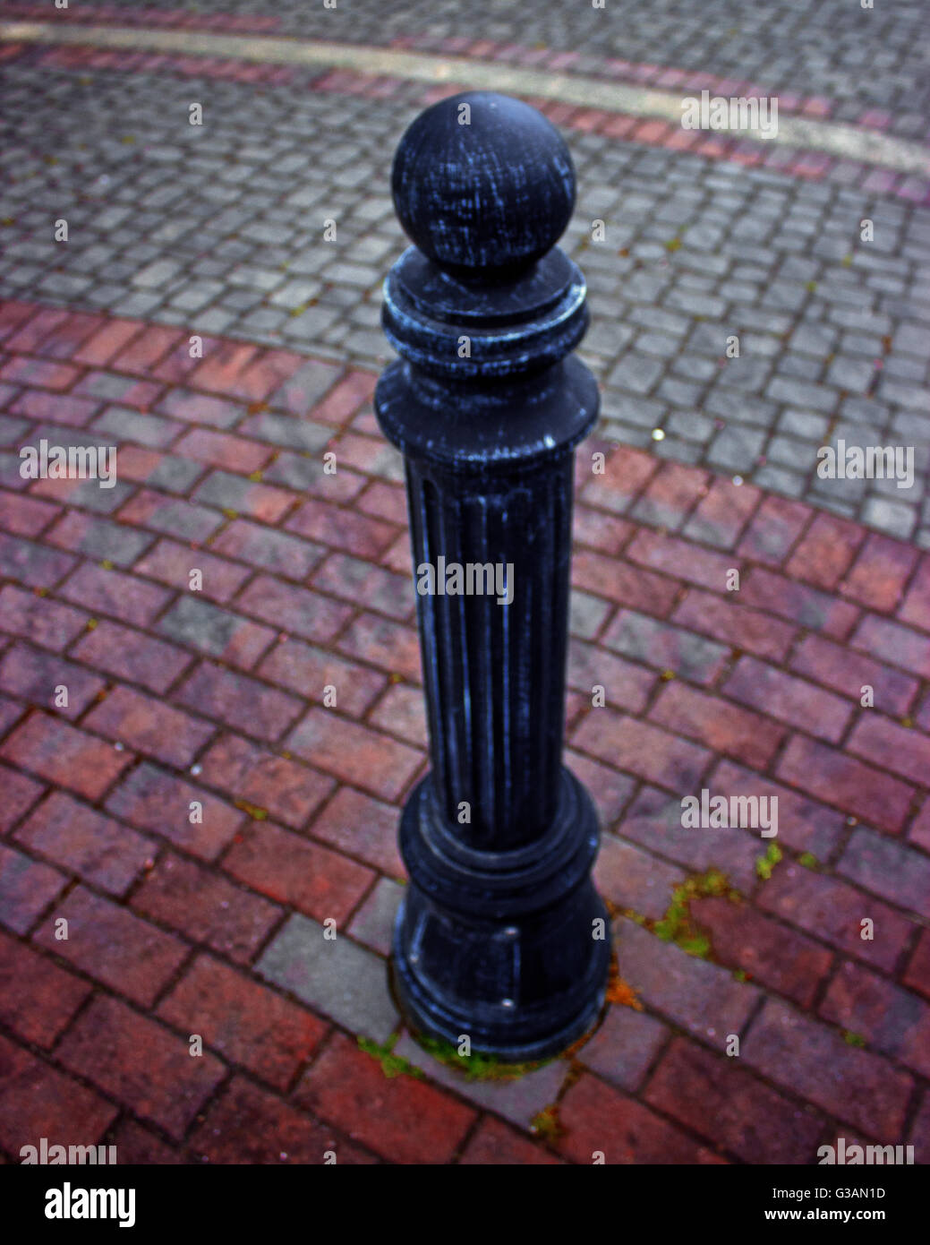 Post stands atop colorful brick patterns Stock Photo - Alamy