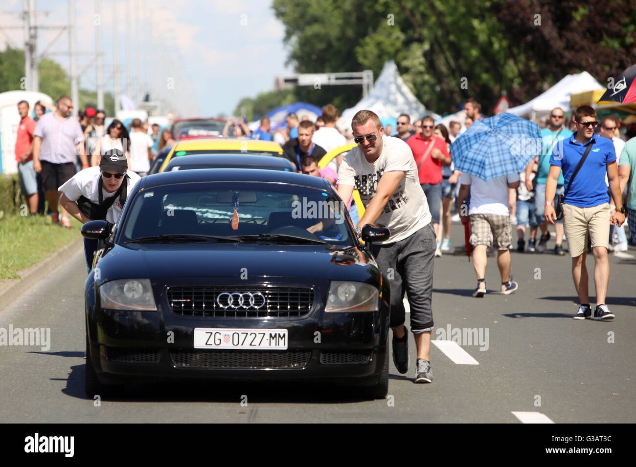 Drivers pushing cars to the line for the start of a race at Fast and ...