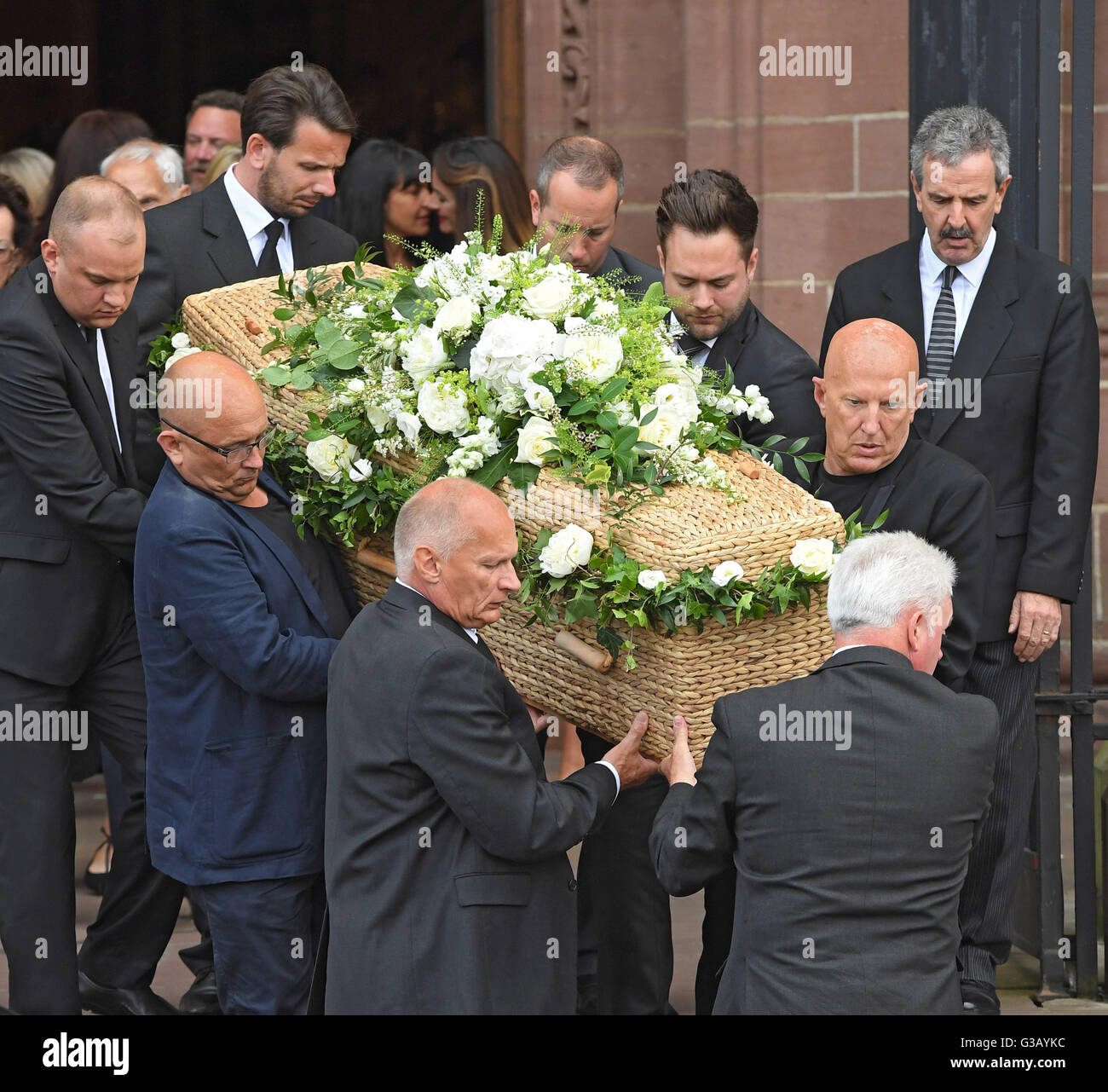 (Front left-right) Nigel and Carl Hollins carry the coffin of their ...