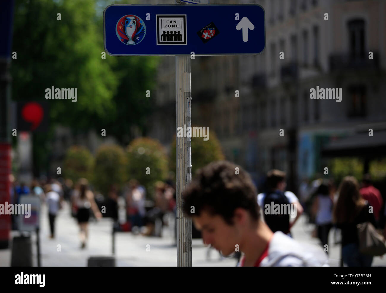 A pedestrian walks past a sign indicating the direction for the fan ...