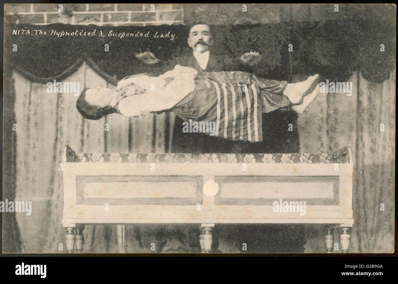 A magician performs a levitation trick on stage: Nita, the hypnotised ...