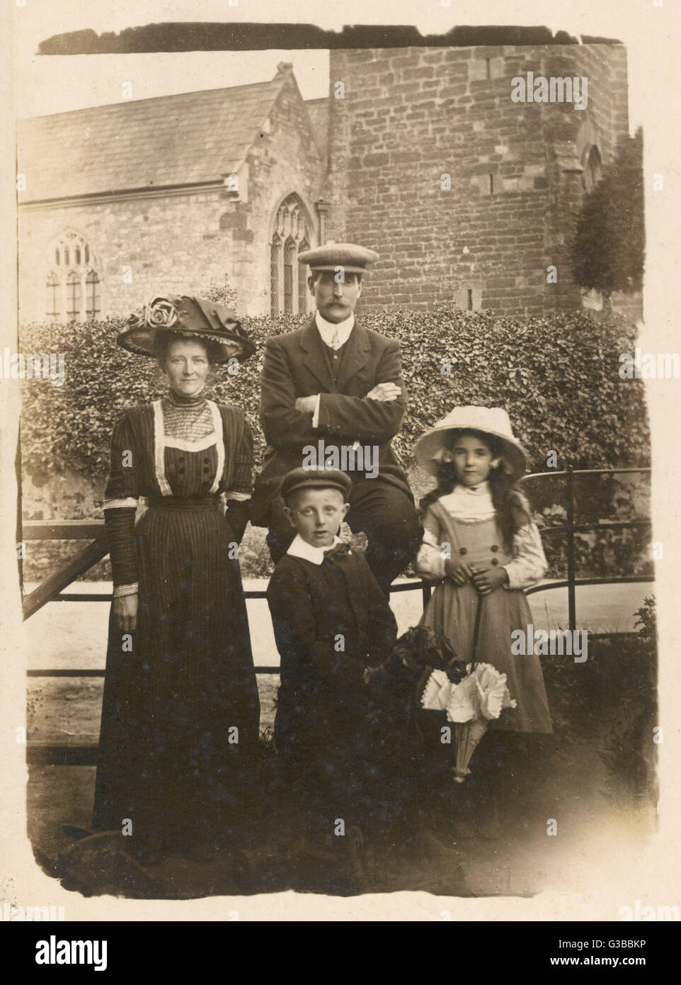 A couple and their two children pose in their Sunday best outside a ...
