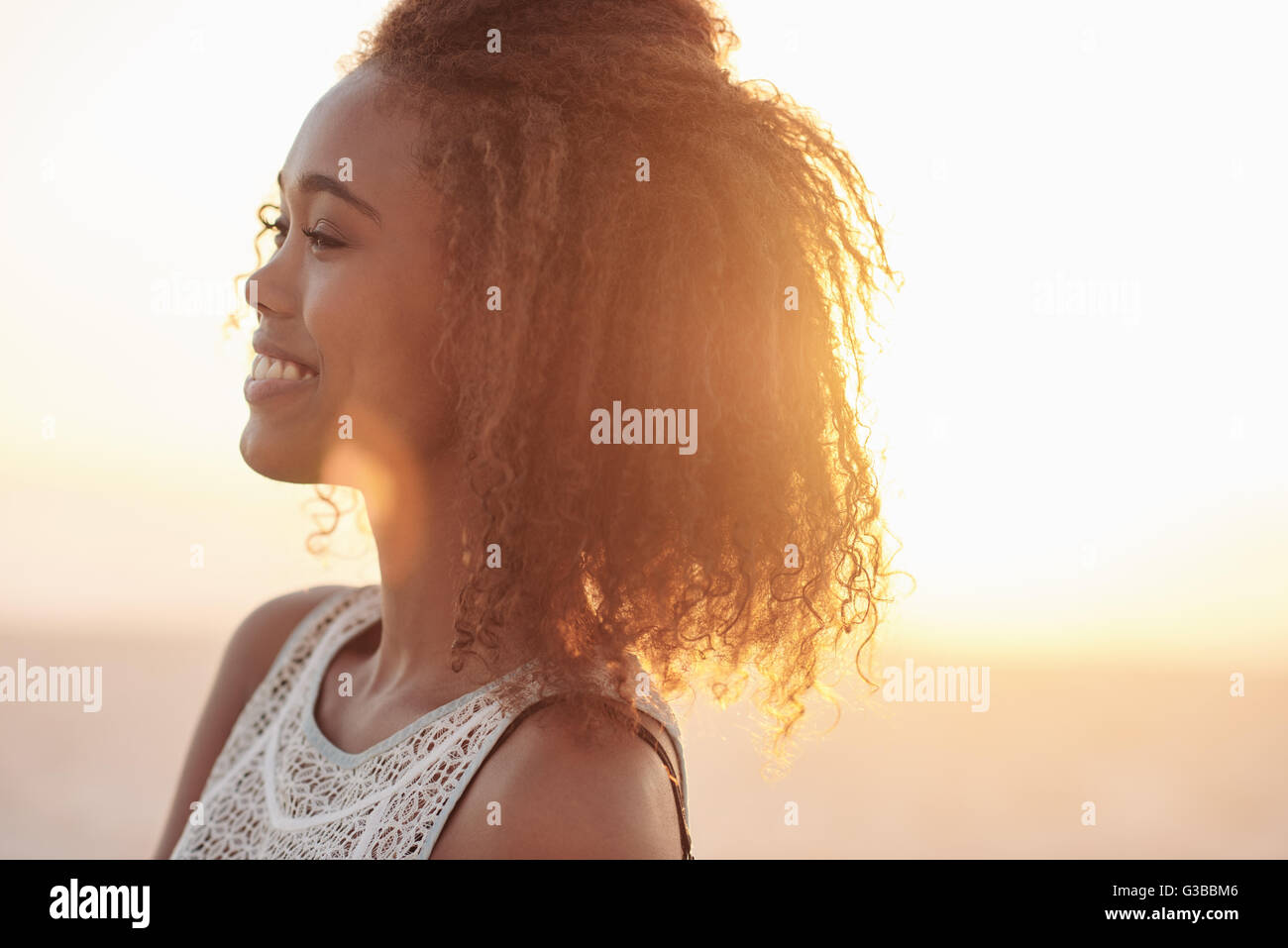 Smiling on sunset beach Stock Photo - Alamy