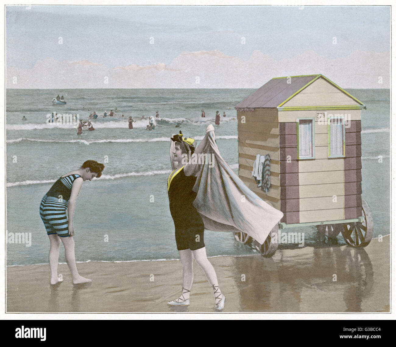 Women on a beach beside their bathing machine. Date: 1890s Stock Photo ...