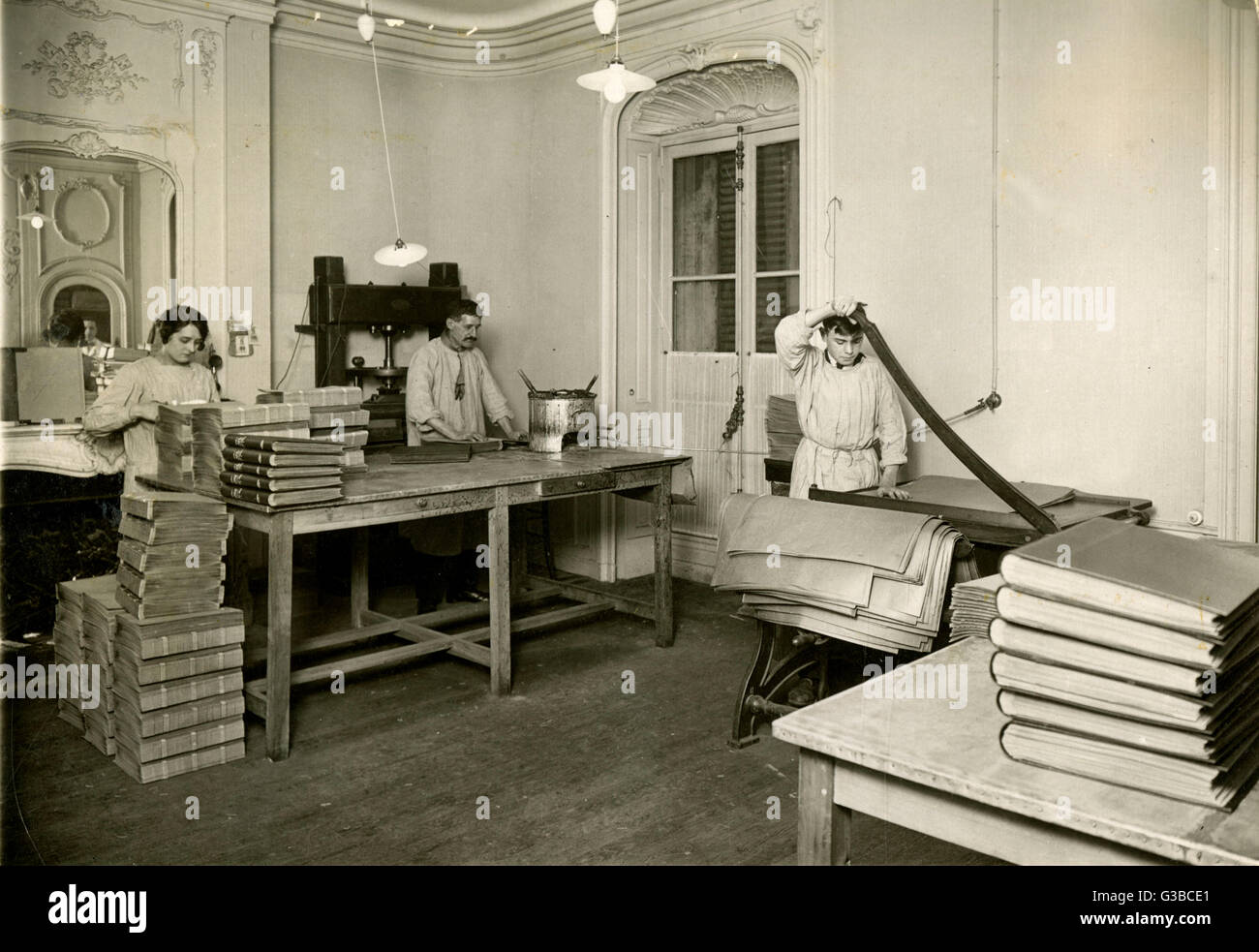 Binding Braille books for the blind. The large volumes each contain 100 ...