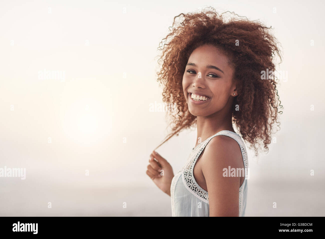 Brightening up sunset with her smile Stock Photo - Alamy