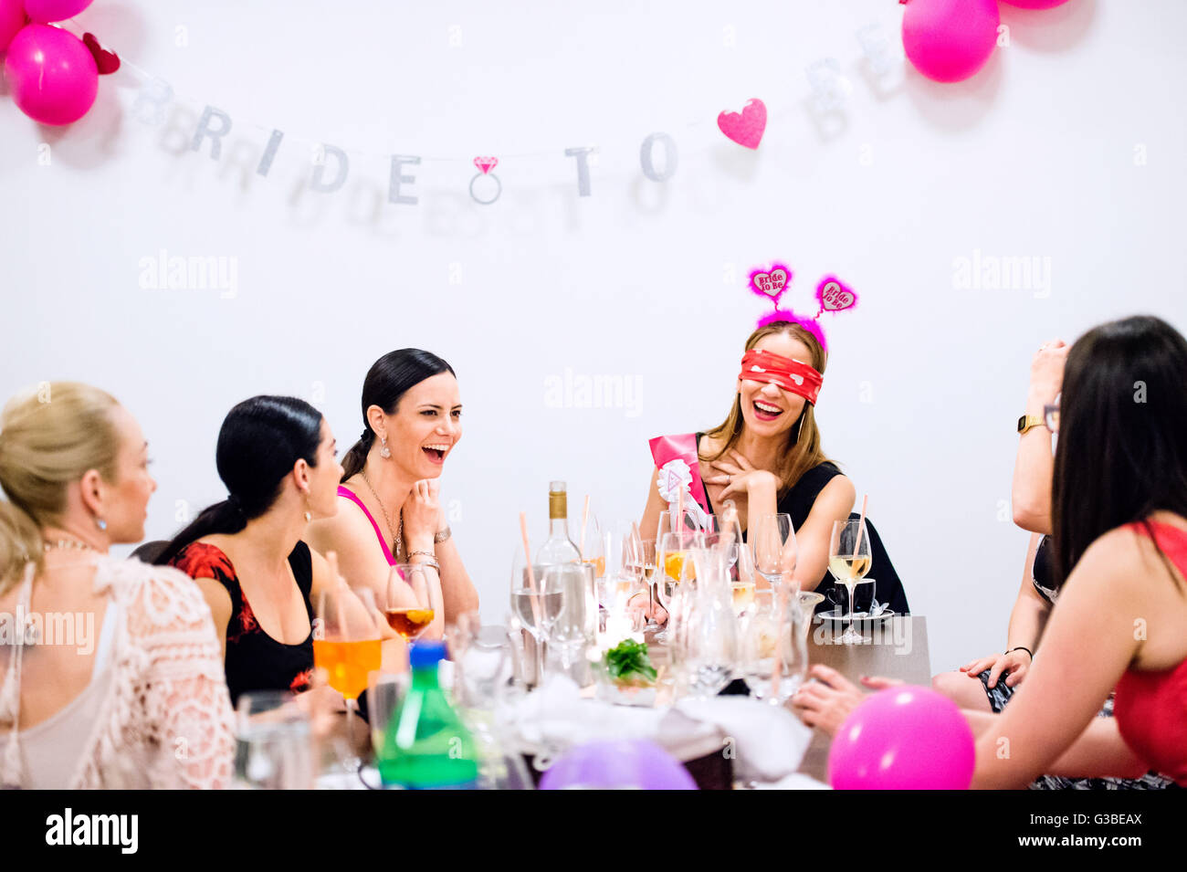 Cheerful bride and bridesmaids celebrating hen party with drinks Stock ...