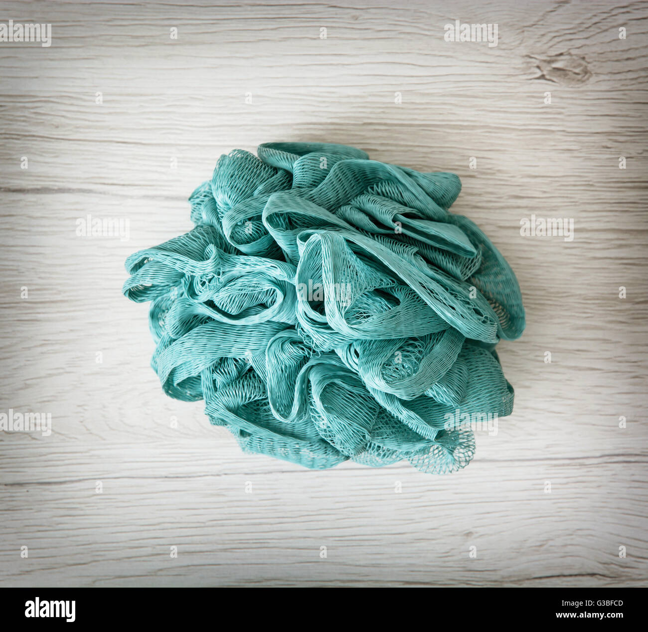 Turquoise washcloth on the wooden background. Body care. Toileting ...