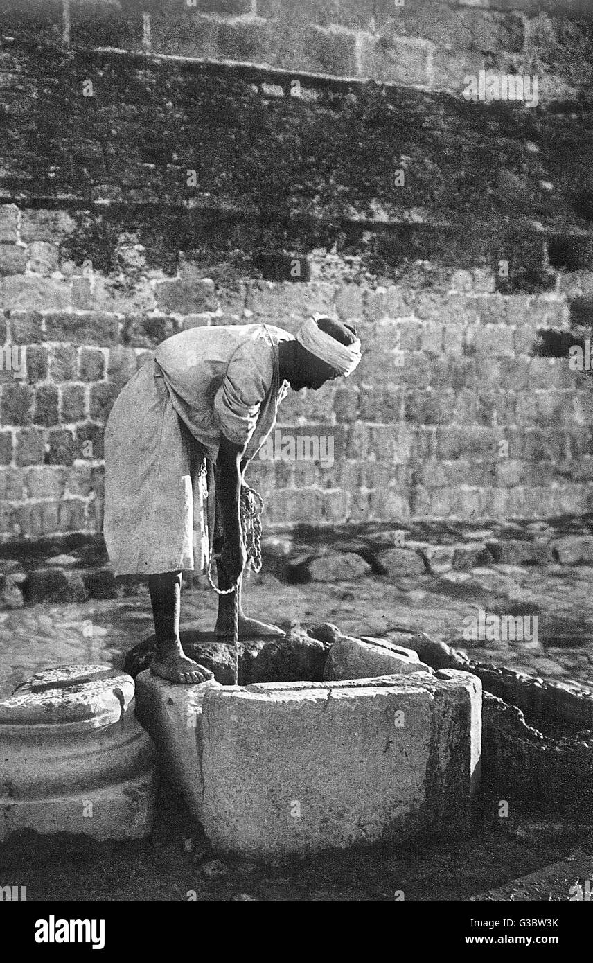 Man drawing water from well hi-res stock photography and images - Alamy
