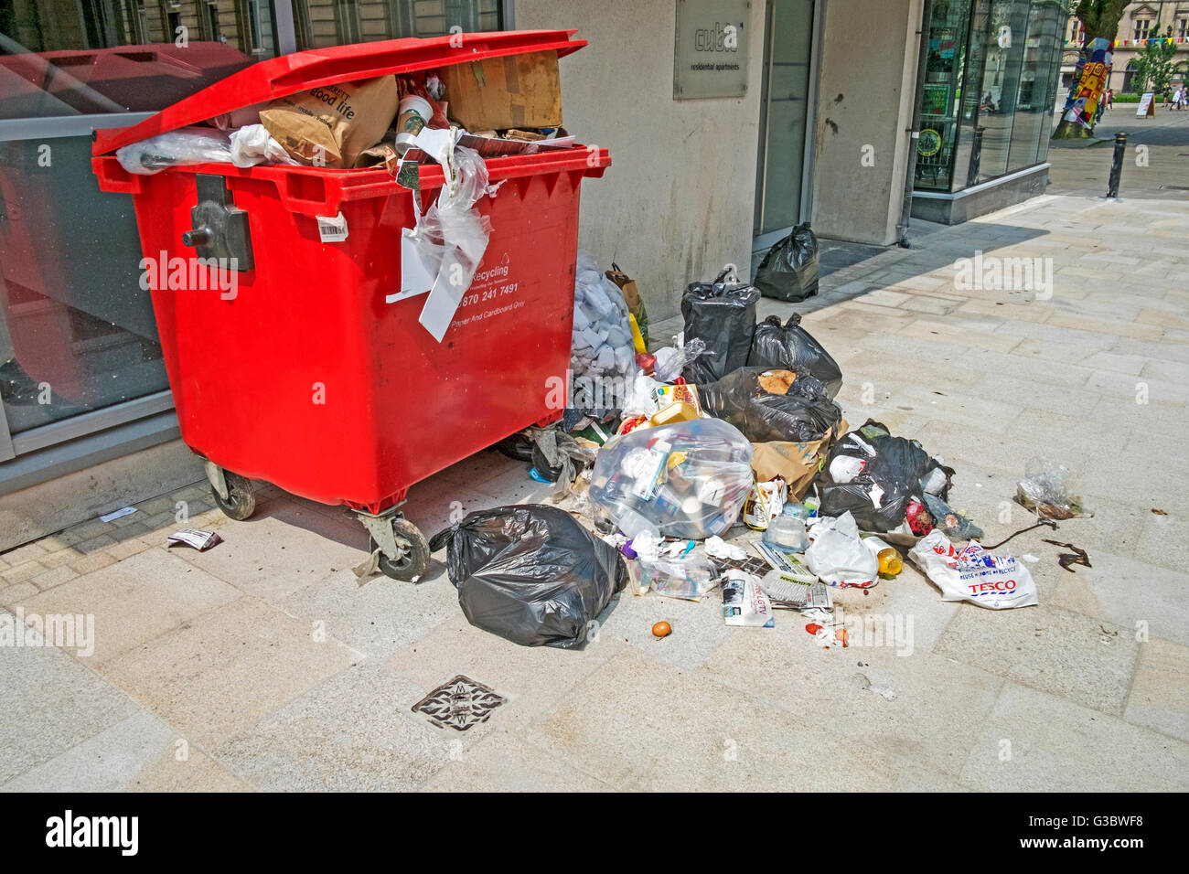 Street cleaner collecting garbage from overflowed bins, garbage, refuse ...