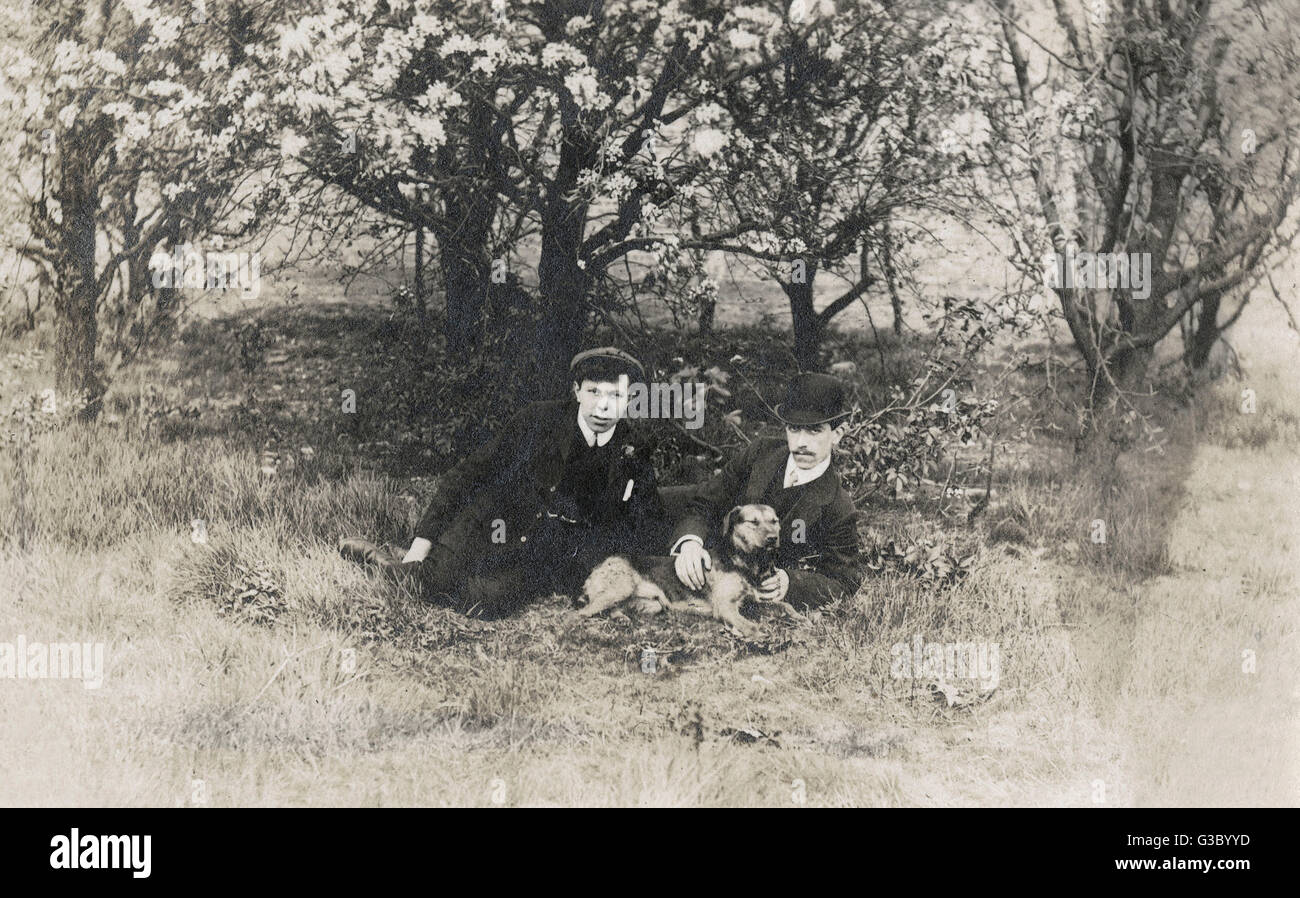 Two men sitting under tree hi-res stock photography and images - Alamy
