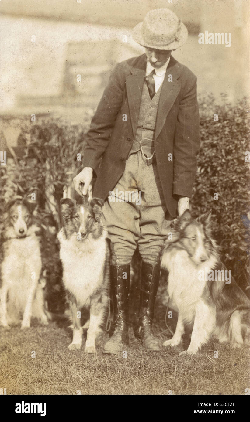 Man with three dogs in a garden Stock Photo - Alamy