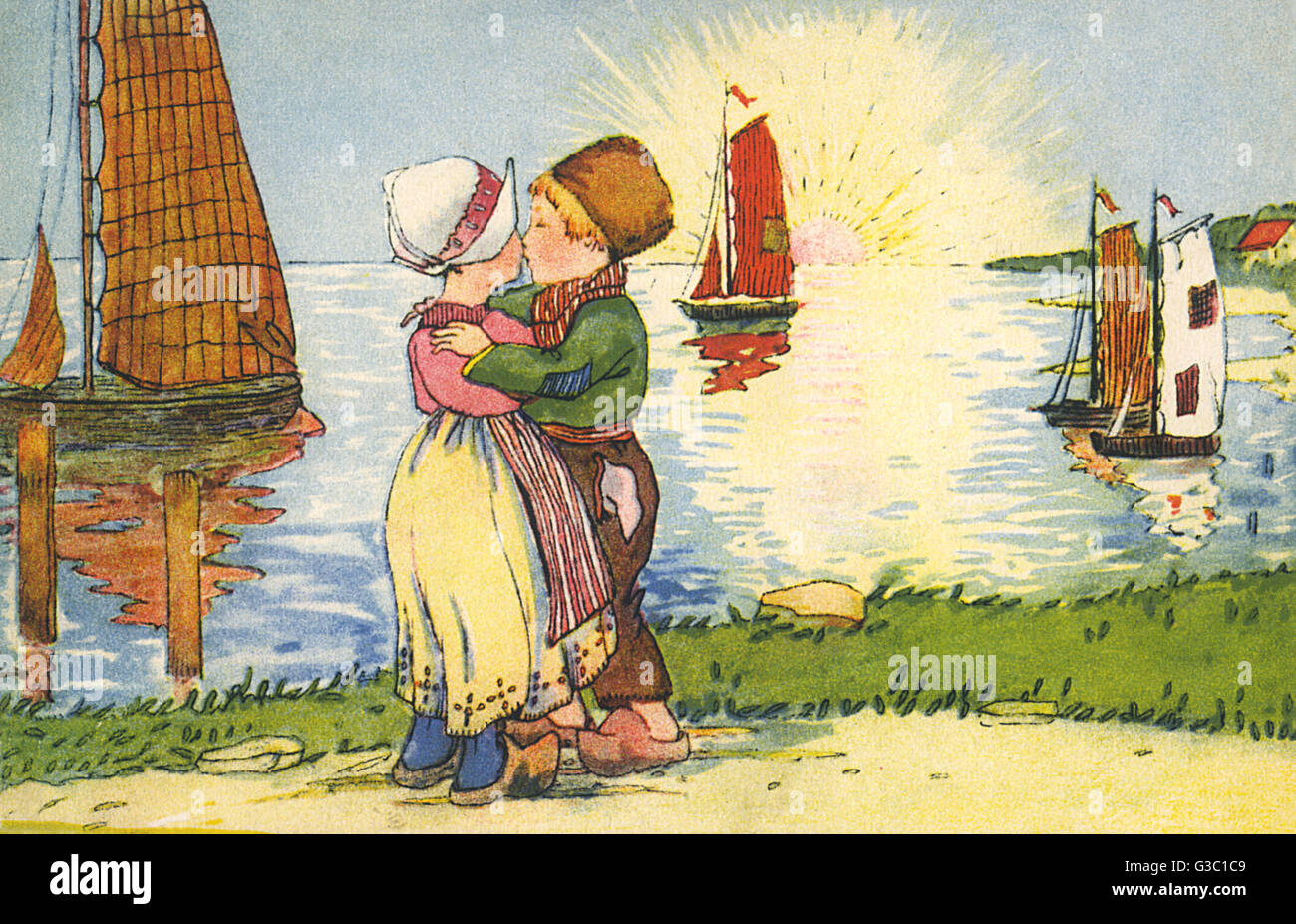 Young Dutch boy and girl share a kiss at sunset Stock Photo - Alamy