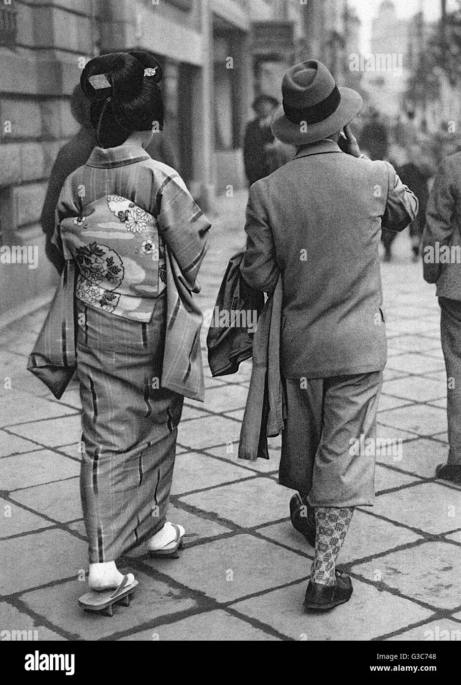 Japanese couple in traditional and western costume Stock Photo - Alamy