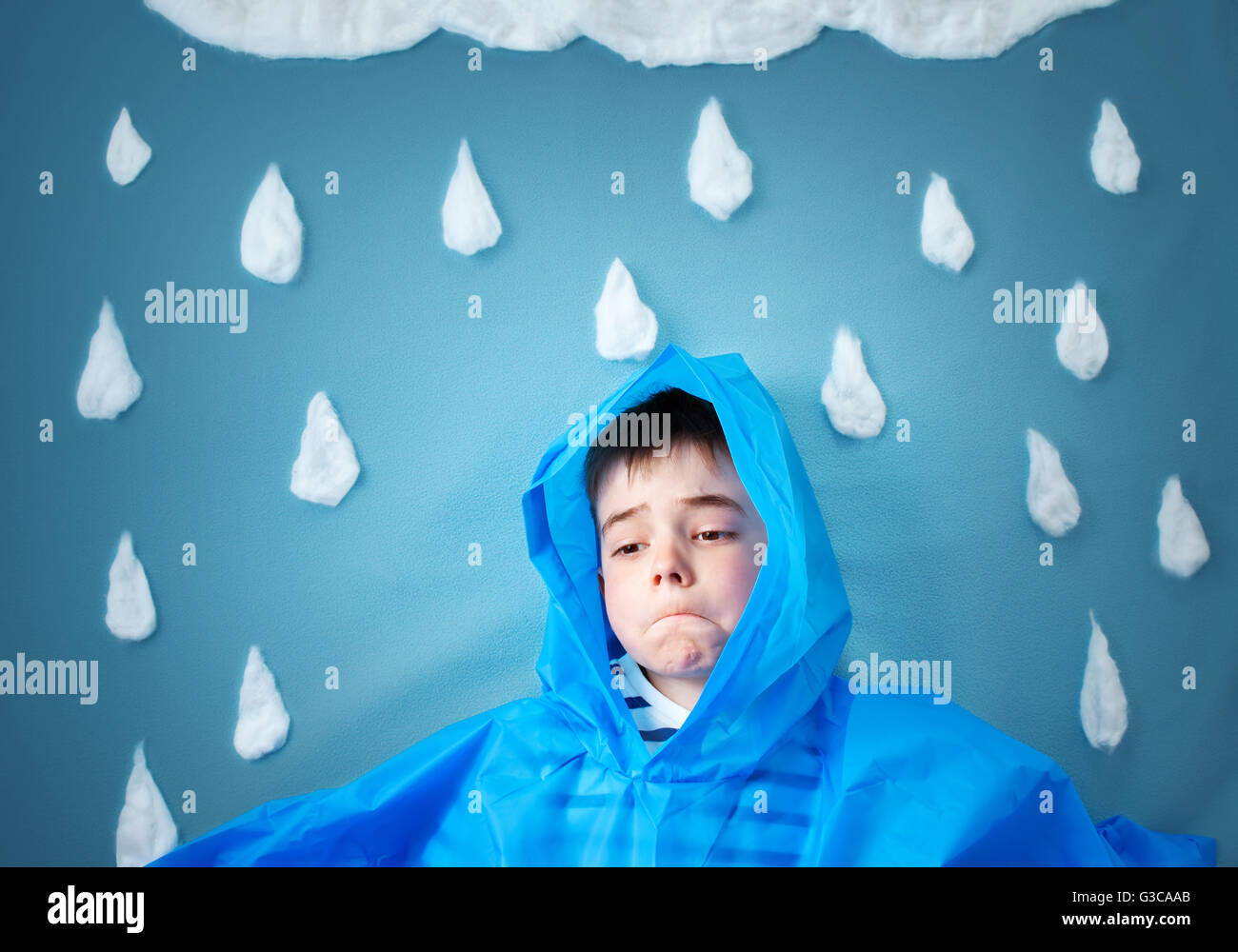 boy on blue background in coat with drop shapes Stock Photo - Alamy