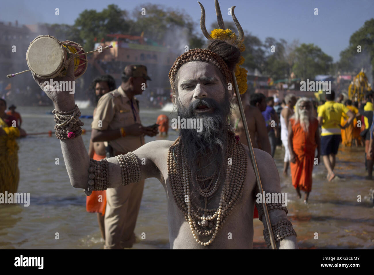Naga sadhu with drum going for Shahi Snaan (Royal Holy Dip) Kumbh Mela ...