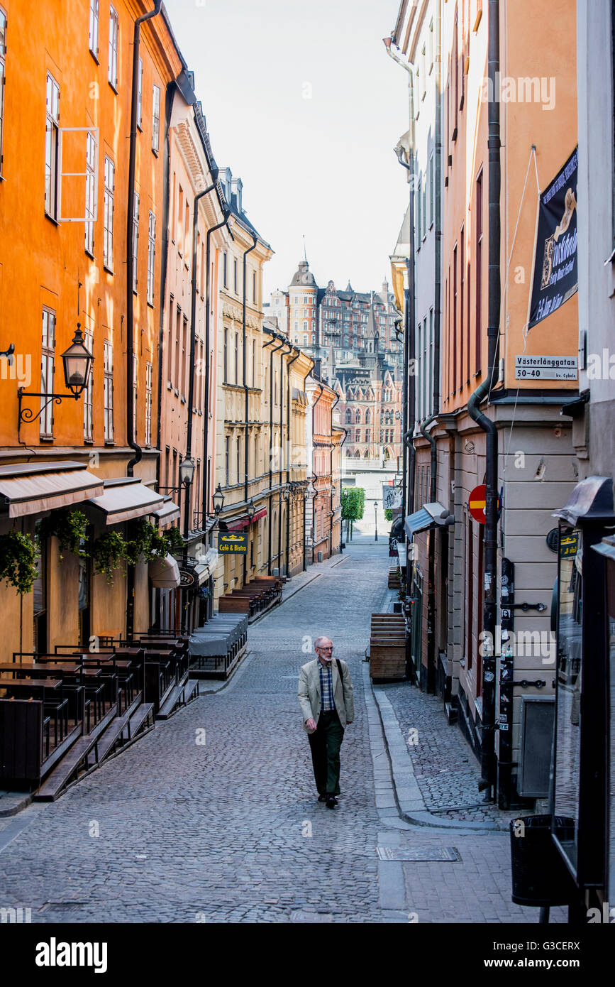 A pedestrian walks the quiet streets of Stockholm's historic Gamla Stan ...