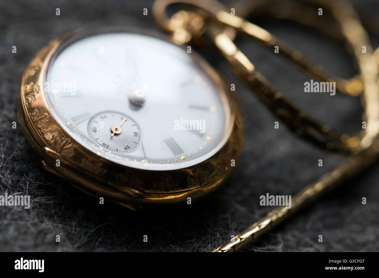 A small golden pocket watch Stock Photo - Alamy