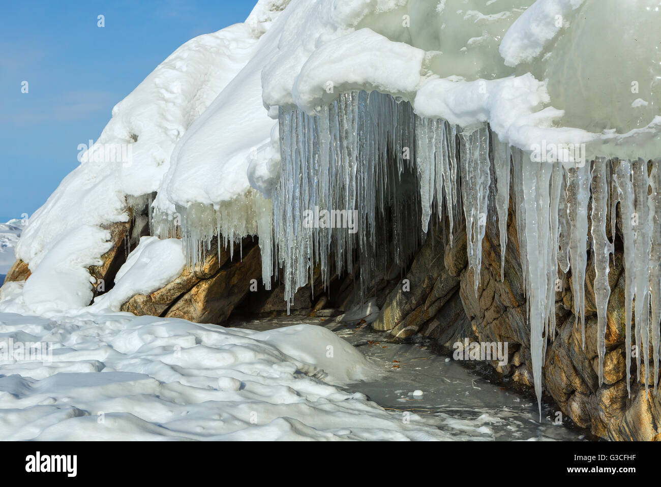 Huge icicles on a cliff Stock Photo - Alamy