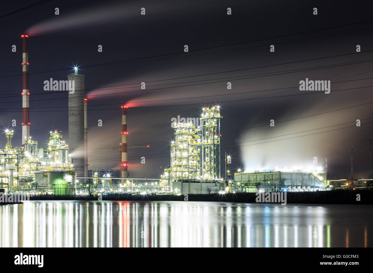 Oil refinery at night Stock Photo - Alamy