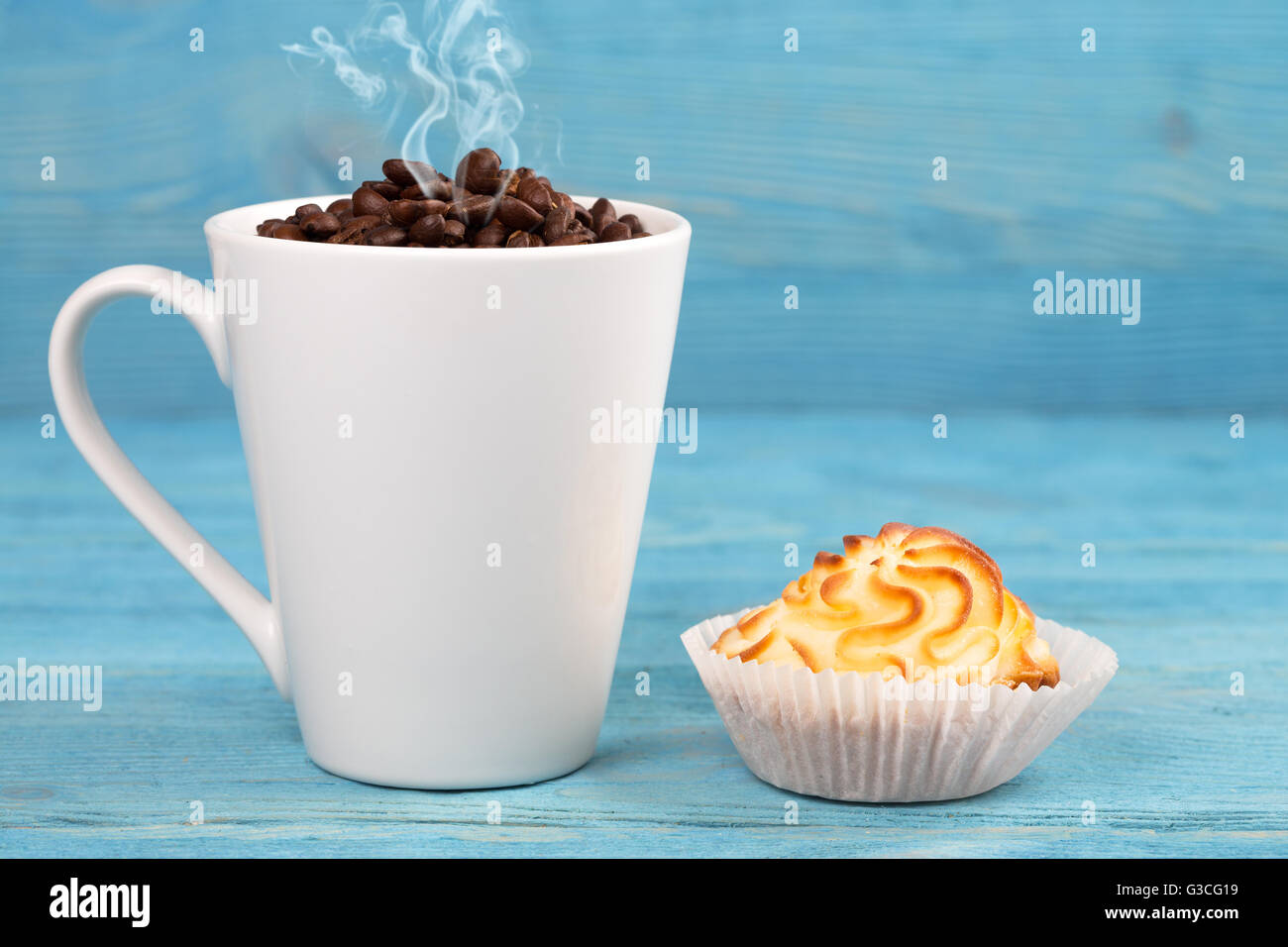 Cup of steaming coffee and cake Stock Photo - Alamy